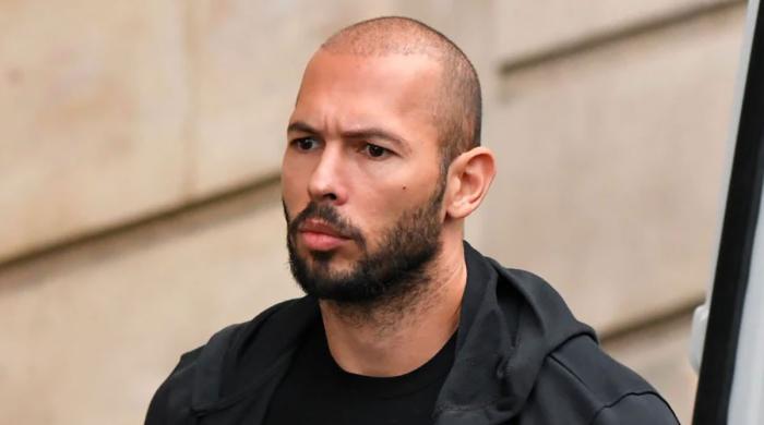 Andrew Tate living in 'dark silence' while in solitary confinement