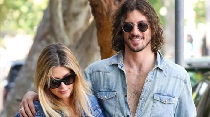 Delta Goodrem and Matthew Copley cuddle at BST Hyde Park