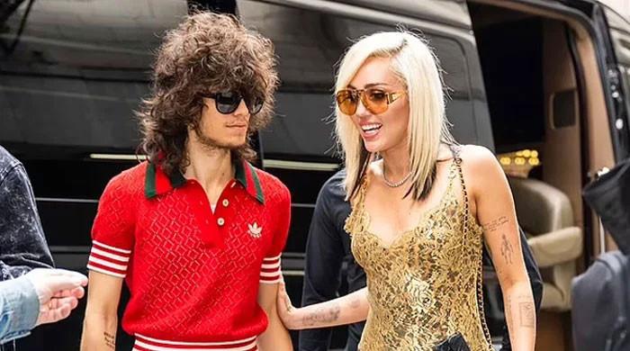 Miley Cyrus shares rare moment of PDA with beau Maxx Morando backstage