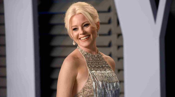 Elizabeth Banks celebrates 50th birthday in golden catsuit