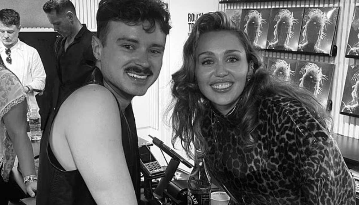 Miley Cyrus drops playful hint while signing album for fan